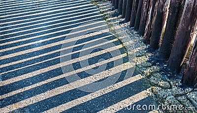 Parallel Shadows Of A Row Of Wooden Poles Stock Image | CartoonDealer ...