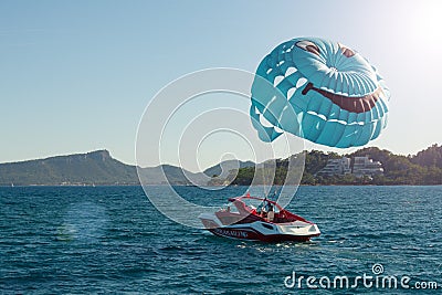 Parasailing, A Red And White Boat Pulls A Blue Parachute With A Smiley ...