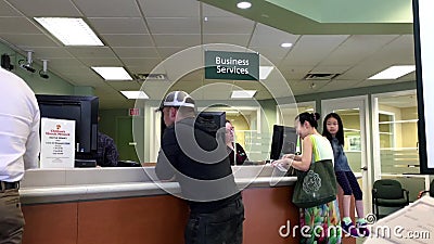 People At A Bank Counter Talking To The Teller Stock Footage - Video of ...
