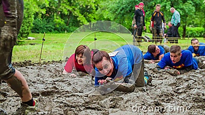 Woman Crawling Through Mud As Part Of Obstacle Course Stock Video ...