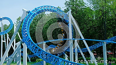 People Ride Upside-down Circle on Blue Roller Coaster Stock Footage ...