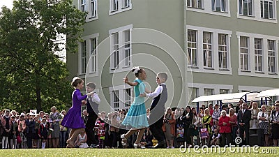 Performance of Two School of Dancing Couples on a Green Grass in Front ...