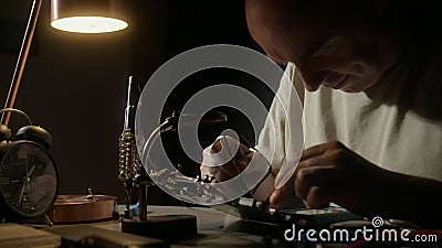 A Person Using a Multimeter Studies a Microcircuit Looking for an Open ...