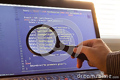 PHP Back-end Code Zoomed Through A Magnifier. Computer Programming Source Code Lookup. Abstract ...