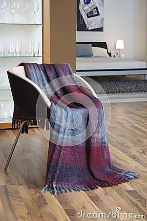 Plaid Draped Over A Chair Royalty Free Stock Image - Image: 9751536