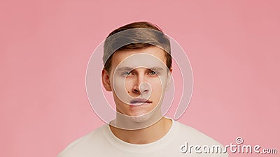 Playful Millennial Guy Biting Lips Posing Over Pink Background Stock ...