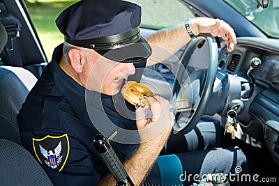 Police Officer Eating Donut Stock Image - Image: 6492661