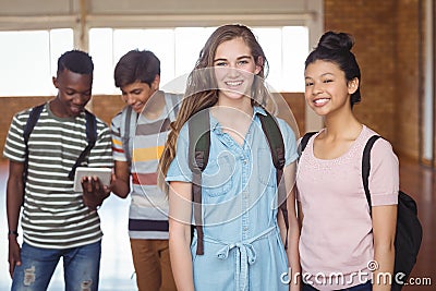 Portrait Of Schoolgirls Standing With Classmate With Classmates In ...
