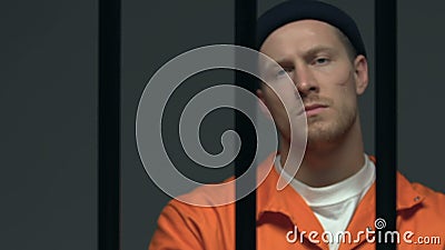 Prisoner With Scars On Face Looking With Confidence On Camera Behind ...