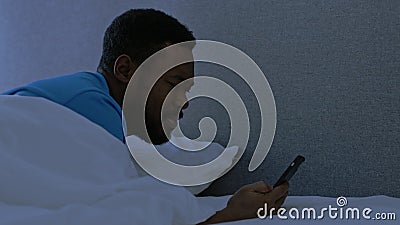 Problems with Dream. Young Black Man Waking Up in Bed, Looking at Phone ...