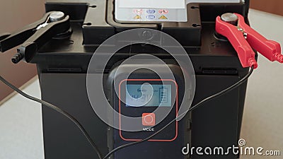 The Process of Charging a Car Battery. the Charger Shows Rising Voltage ...