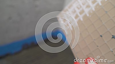 The Worker Holds a Ceramic Tile in His Hand. the Process of Laying ...