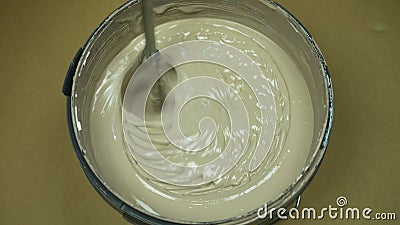 The Process of Mixing Paint in a Bucket before Applying it To the Walls ...