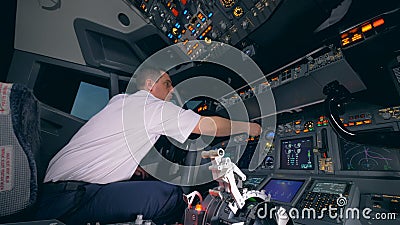 Professional Aiplane Pilot is Turning Indicators on a Cockpit Cabin ...