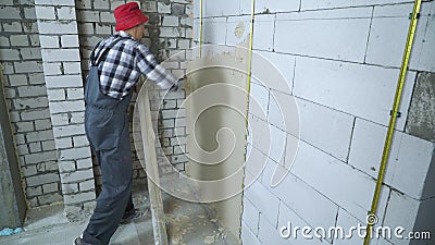 Professional Builder Leveling Plaster On Block Wall Using Ruler Stock ...