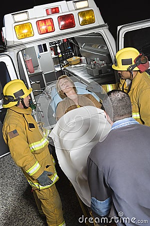 Professionals Carrying Patient On Stretcher In Ambulance Royalty Free ...