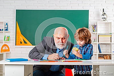 Professor And Pupil In Classroom At The Elementary School. Child At ...
