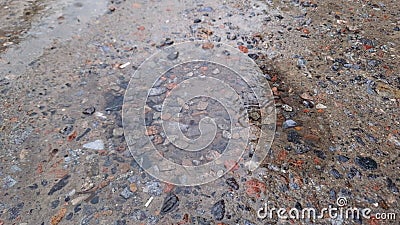 Puddle of Rainwater on Concrete and Gravel Surface during Rain Stock ...