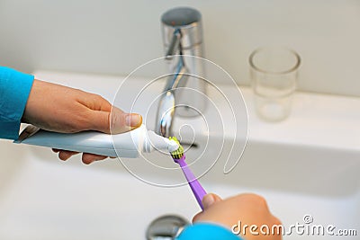 Putting Toothpaste On Toothbrush Stock Photography - Image: 18410152