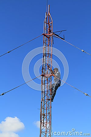 Radio Tower Worker Climbing On A Tower Stock Photos - Image: 26318353