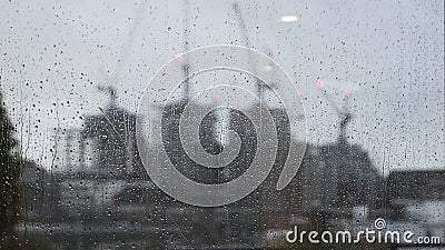 Rain Falling Down on Window with Blurred Construction Cranes in ...