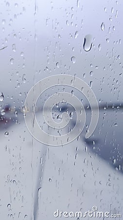 Rain Streaming Down the Window of an Airplane with View of the Wing and ...