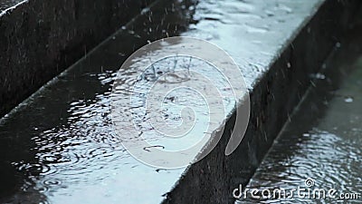 Raindrops Falling on the Steps with a Splash; Close Up of Water on the ...