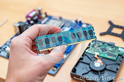 RAM Memory Module In Hand. Motherboard And Hard Disk In Background ...