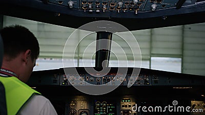 A Pilot Checking Instruments in a Plane Cockpit. Rear View of Pilot ...