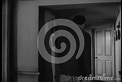 Rear View of Woman Sneaking Up on Man in Hallway Stock Footage - Video ...