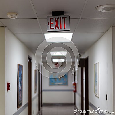 Red Emergency Exit Sign In The Dark Room. Illuminated Office Exit Sign ...