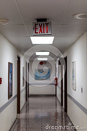 Red Emergency Exit Sign In The Dark Room. Illuminated Office Exit Sign ...