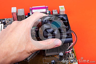 Removing An Small Old CPU Cooler From The Motherboard. Human Hand ...