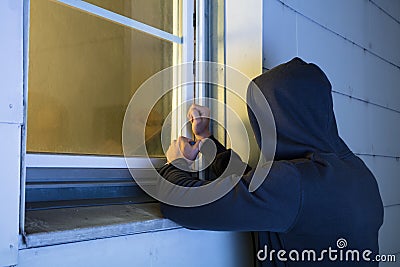 Robber Using The Crowbar To Open The Glass Window Stock Photo ...