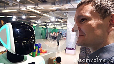 Robotics Technology. Guy Talk with Robot. Robot Head with Camera Scan ...