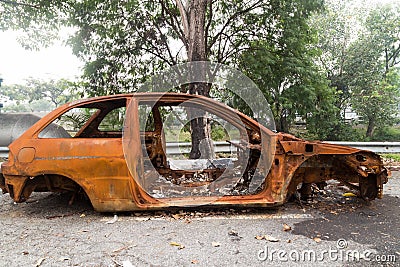 Rusty Chassis Of A Burnt Car Abandoned By The Side Of The Street ...