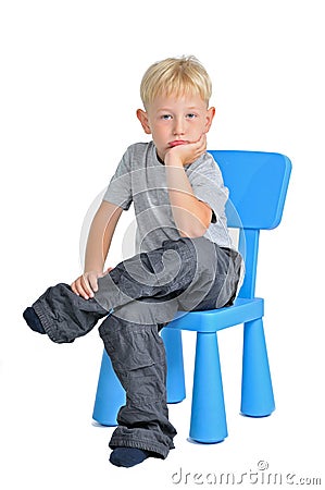 Sad Boy Sitting On A Chair Stock Image | CartoonDealer.com #24734443