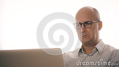Sad Man Browsing Email in Notebook Computer and Looking into Camera ...
