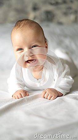 Satisfied Smiling Baby Lying On His Stomach On A White Background ...
