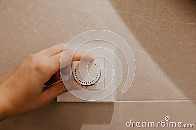 Saving Energy Concept: Human Hand Turning Down Electrical Light Dimmer ...
