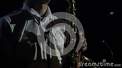 Close Up of a Man Playing Saxophone in Dramatic Lighting Stock Footage ...