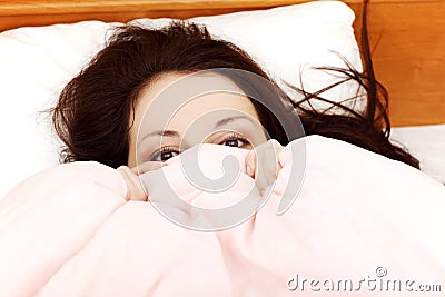 Scared Woman Hiding Her Face Under The Sheet. Royalty-Free Stock Photo ...
