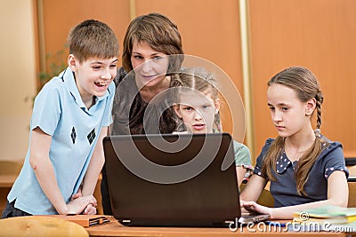 School Kids And Teacher Using Laptop At Lesson Royalty-Free Stock ...