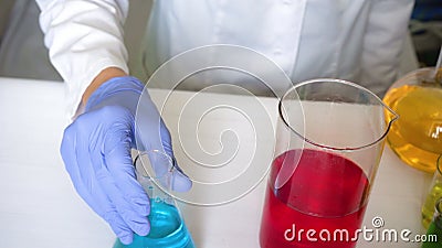 Science Experiment in Laboratory. Chemist Analyzing Red, Yellow, Blue ...