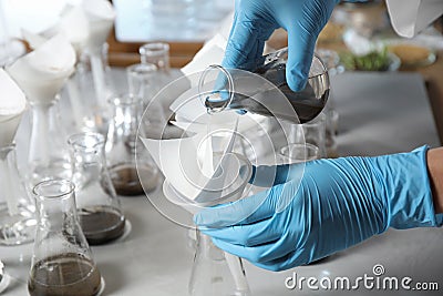 Scientist Filtering Soil Samples At Table. Laboratory Analysis Royalty ...