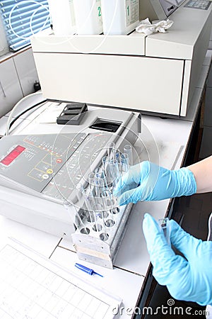 Scientist looking at test tubes - Stock Image - Everypixel
