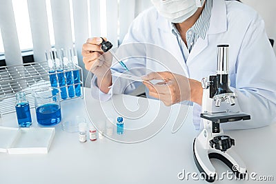 Scientist Woman Holding Dropper To Dropping Solution Sample On The ...