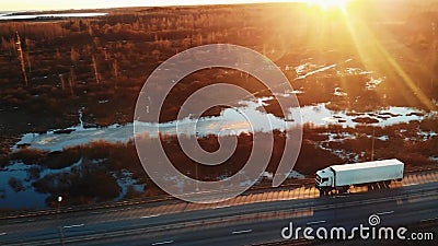A Semi Truck Driving on a Highway into the Sunset, Front View Aerial ...