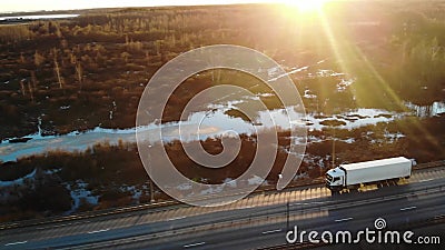 A Semi Truck Driving on a Highway into the Sunset, Front View Aerial ...