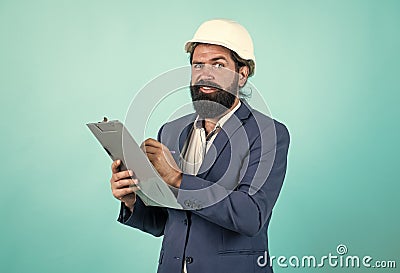 Serious Foreman In Helmet And Suit Writing In Paper Folder, Making ...